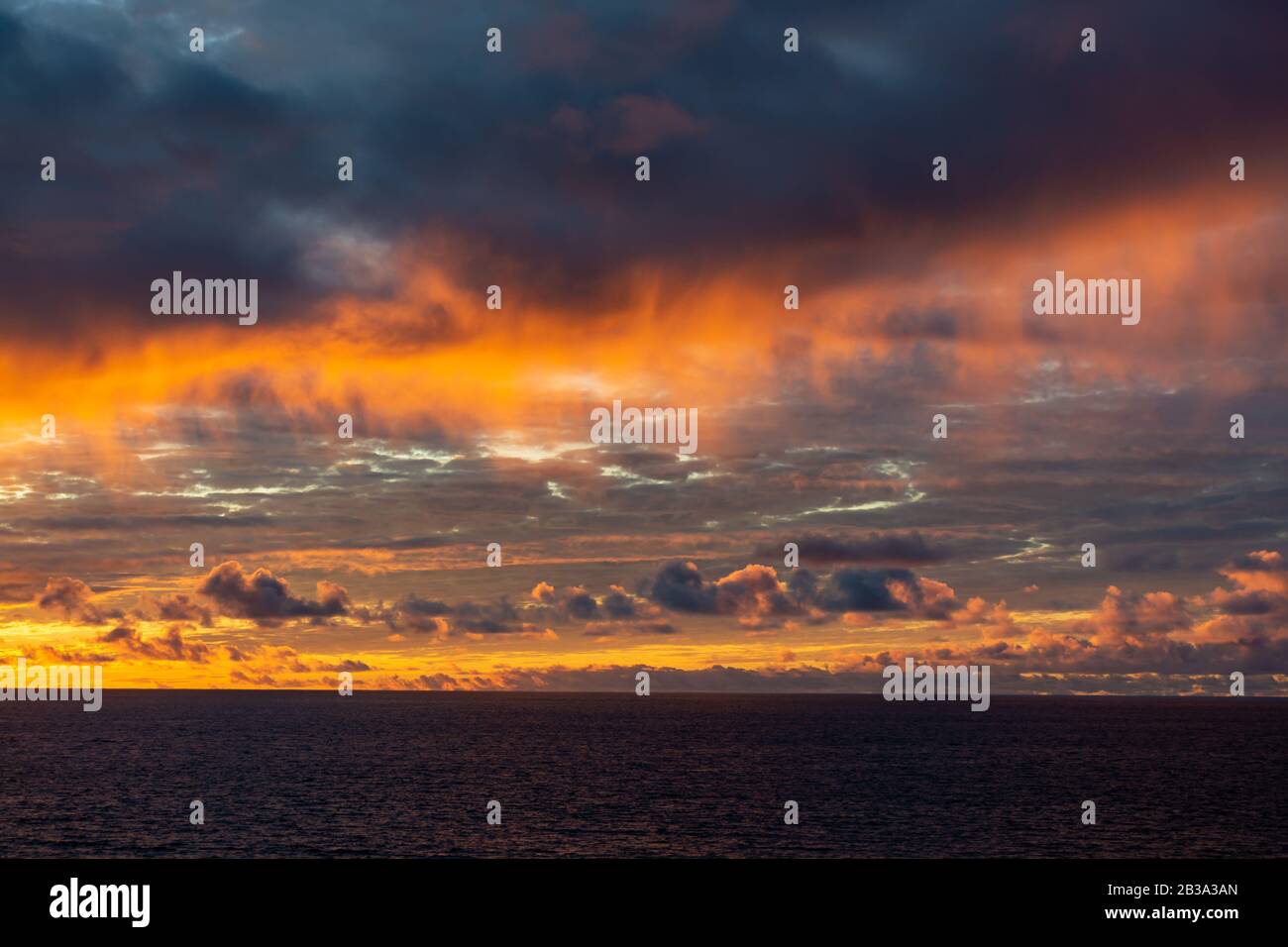 Amazing sunset with colorful cloudscape and dark ocean water, nature ...