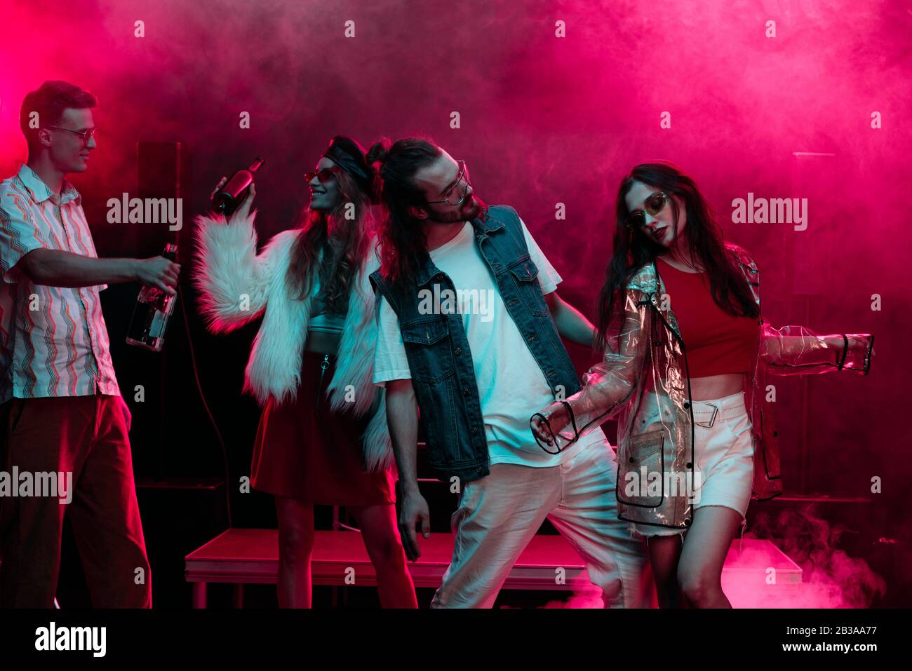 men and girls with alcohol dancing in nightclub with pink smoke Stock ...