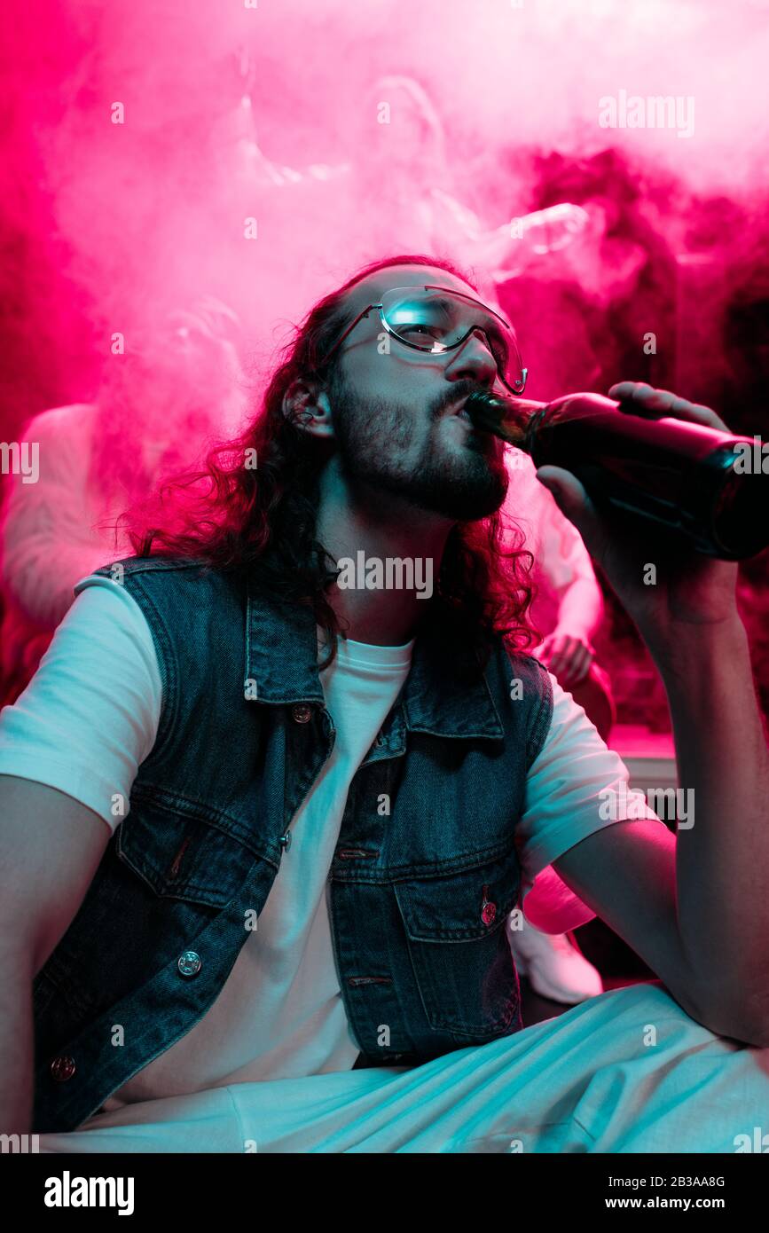 man in sunglasses drinking alcohol during rave in nightclub Stock Photo ...
