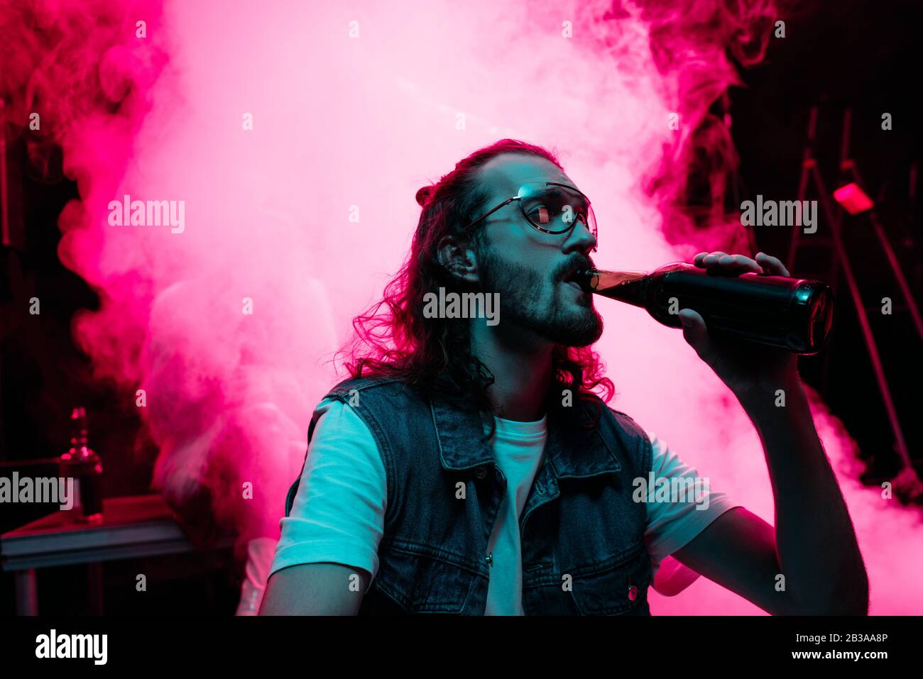 man in sunglasses drinking alcohol during rave in nightclub Stock Photo ...