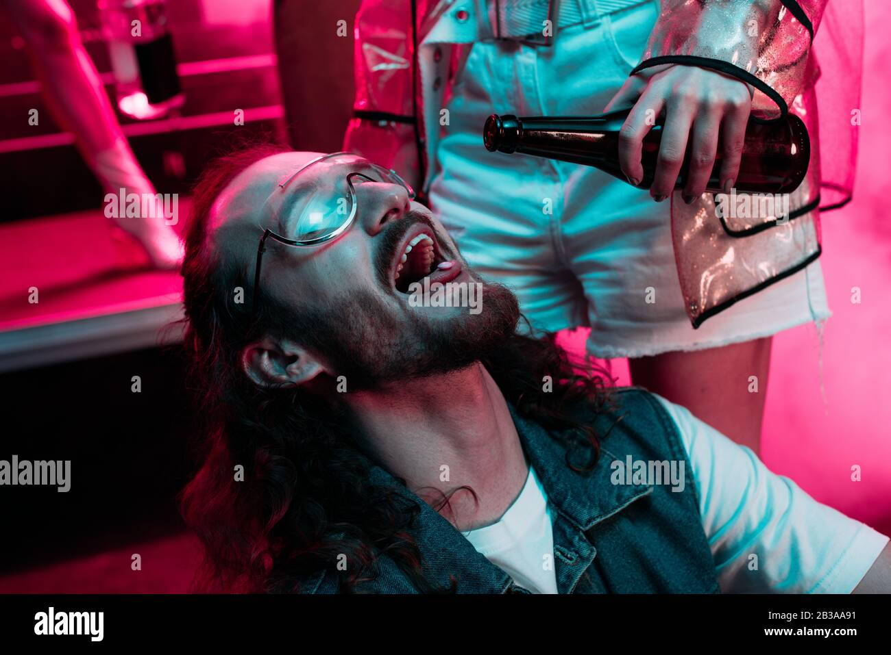 woman pouring alcohol in mouth of man in sunglasses with lsd on tongue ...