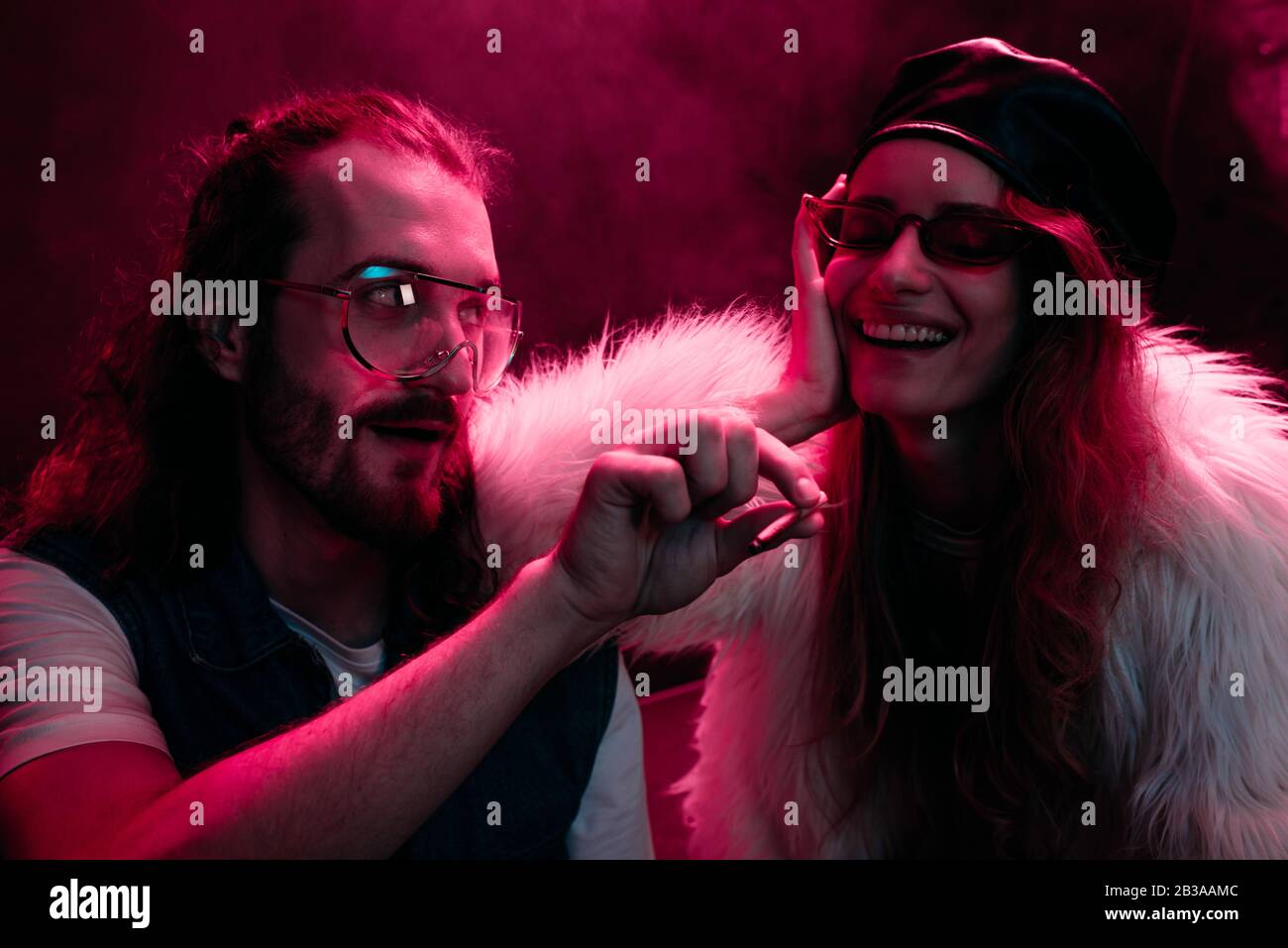 man giving marijuana joint to smiling girl in nightclub Stock Photo - Alamy