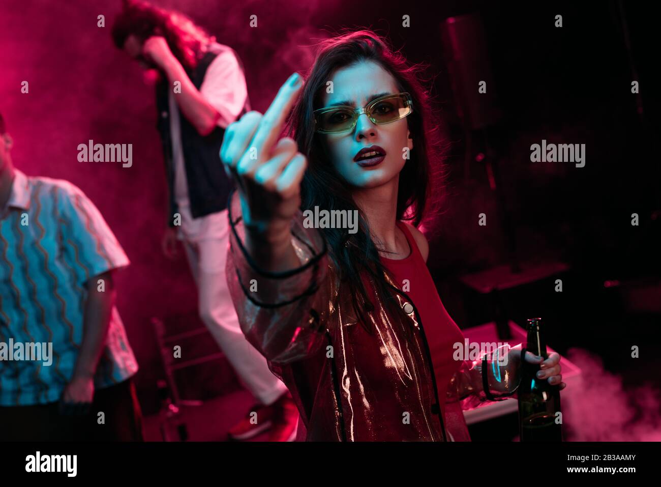 girl with beer showing middle finger in nightclub during rave Stock ...