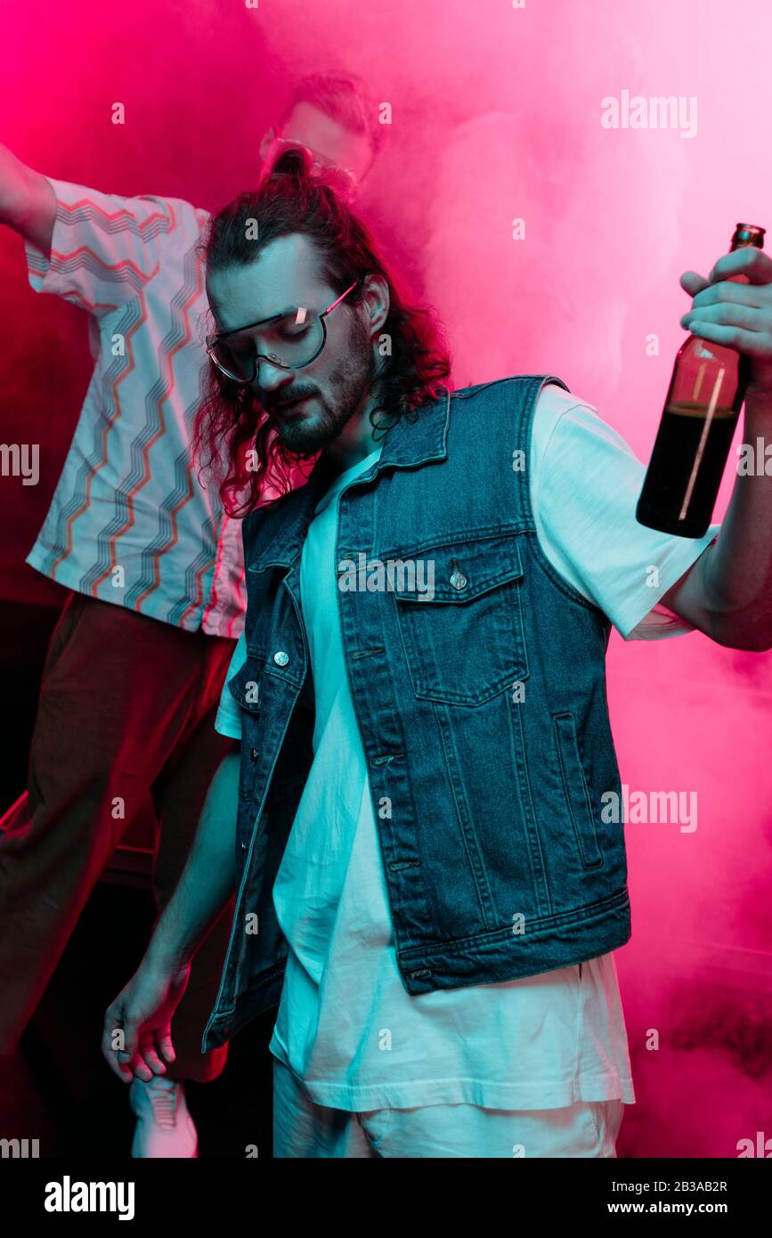 man holding beer in nightclub and dancing during rave Stock Photo - Alamy