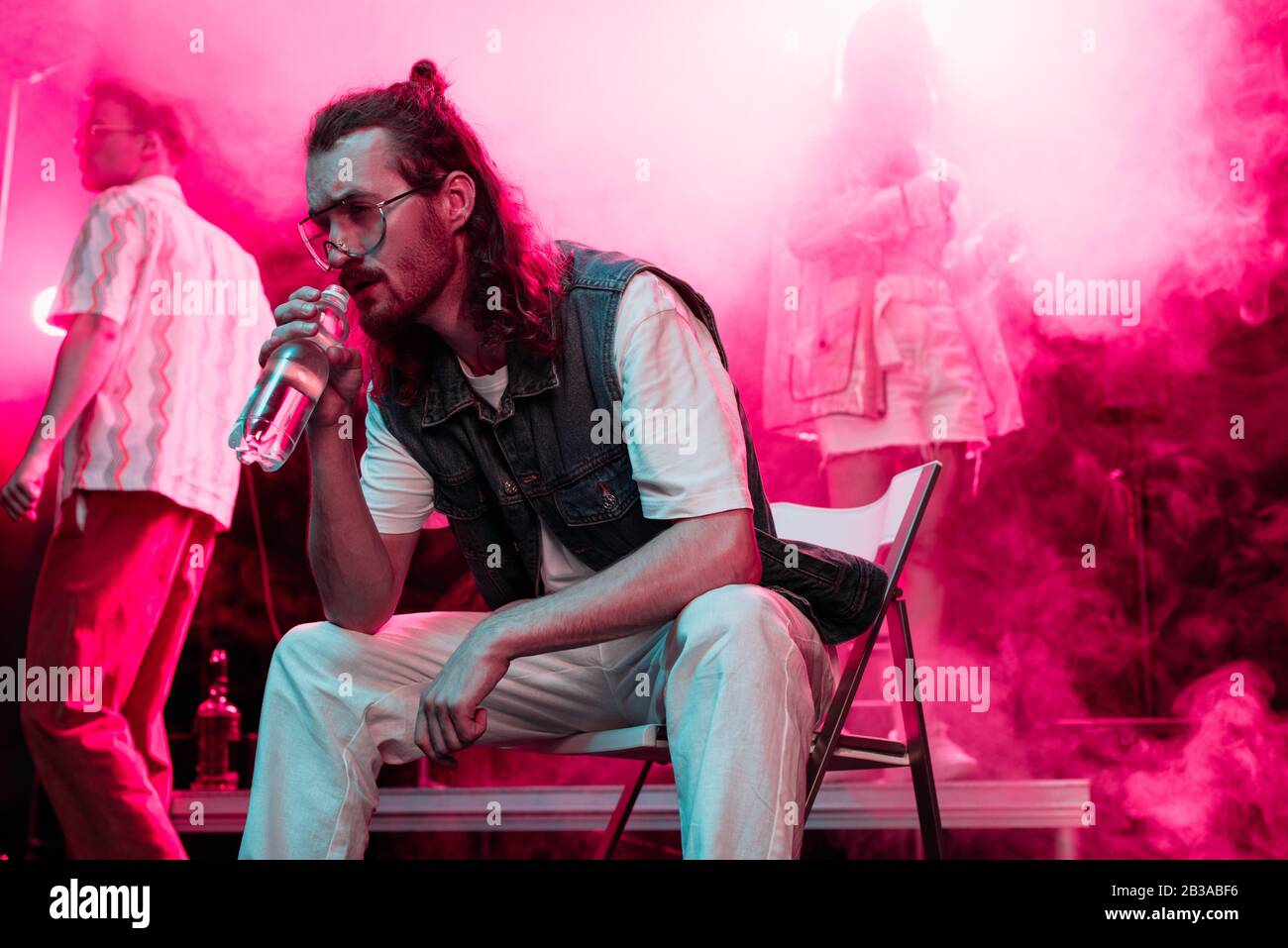 sick man sitting and drinking water in nightclub Stock Photo - Alamy