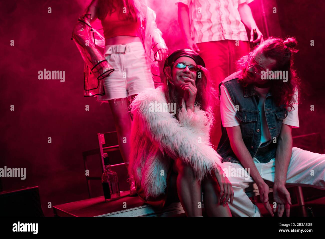 happy man and young woman sitting together during rave party in ...