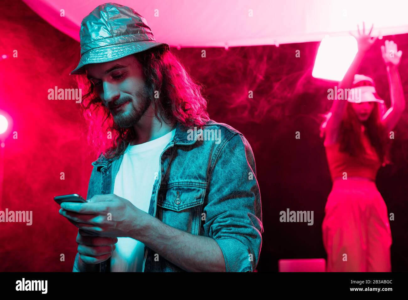 man using smartphone during rave party in nightclub Stock Photo - Alamy
