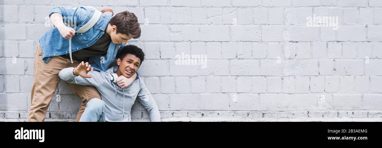 panoramic shot of aggressive boy in shirt bulling, going to punch ...