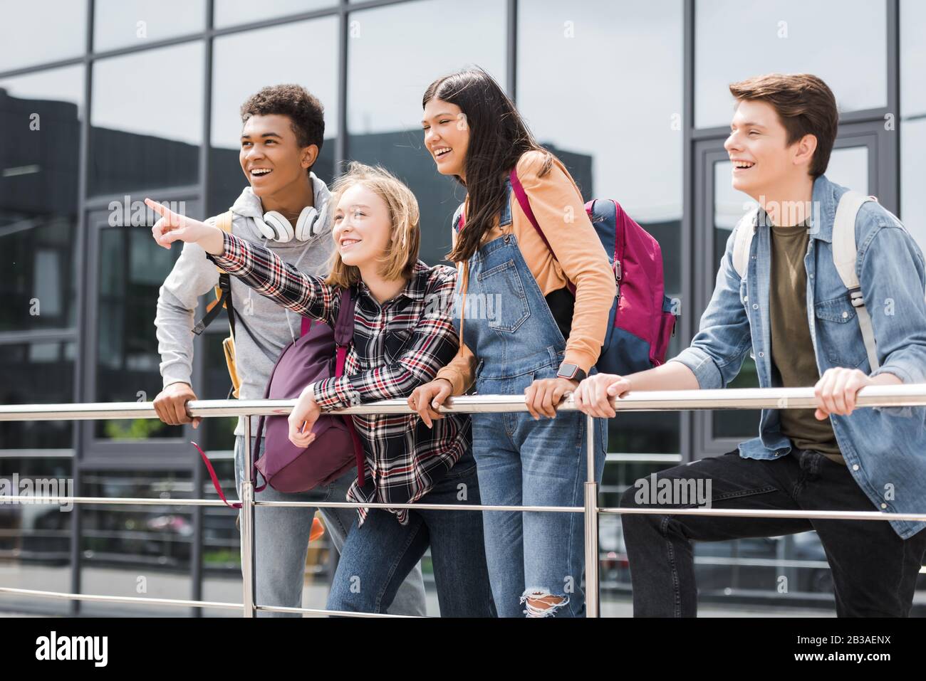 happy friends smiling, pointing with finger and looking away Stock ...