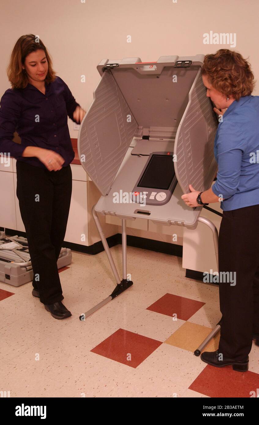 Austin, Texas USA, March 6 2002: Poll workers set up a voting booth ...