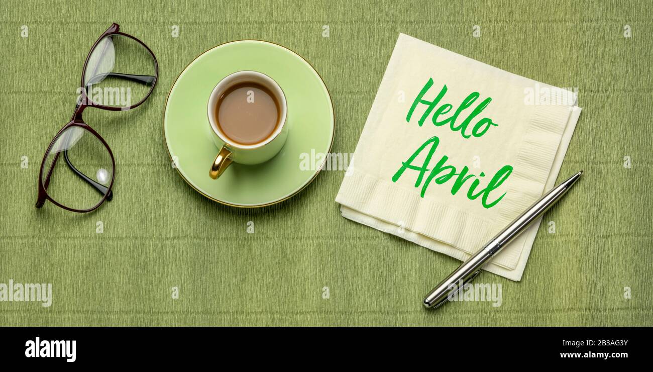 Hello April - handwriting on a napkin, desktop flat lay with a cup of ...