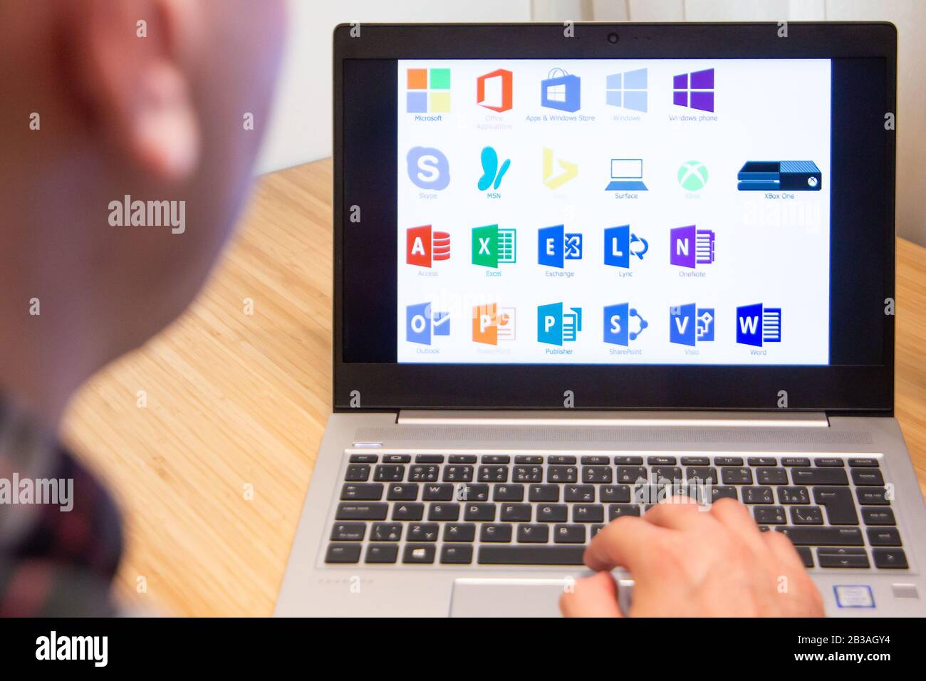 Microsoft services are used by a man on the laptop. Microsoft customer ...