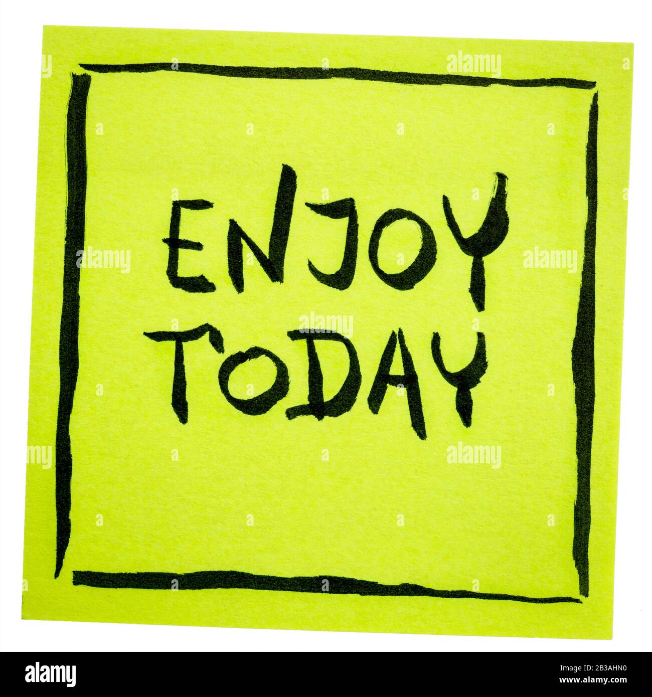 Enjoy today reminder - handwriting on an isolated sticky note, positive ...