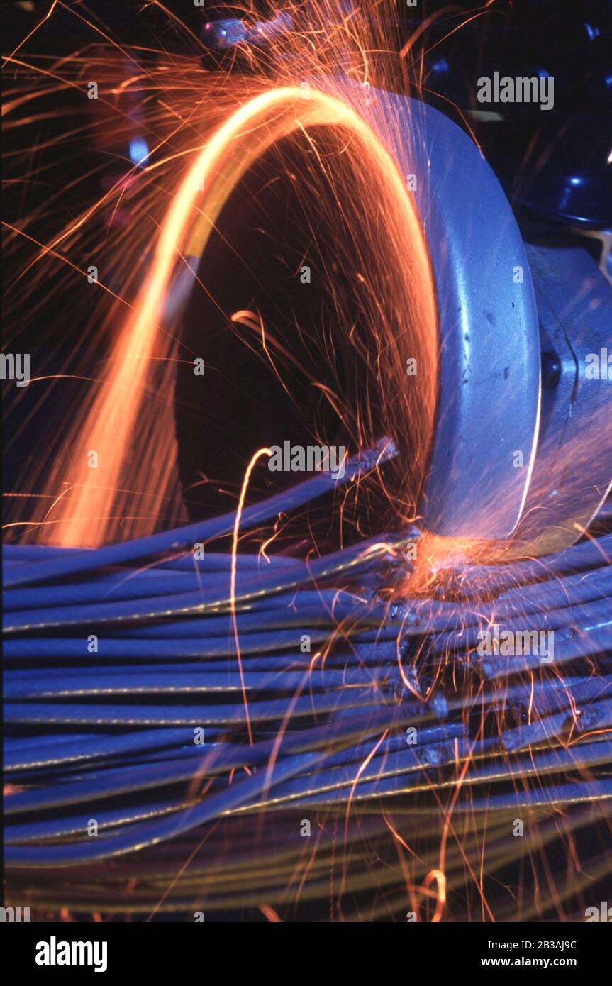 Circular saw blade creates sparks cutting through network cables. ©Bob ...