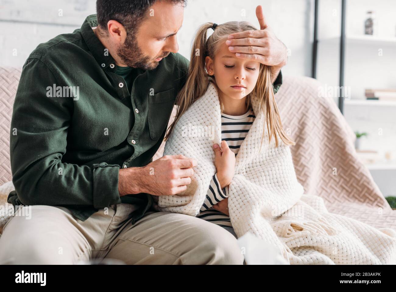 attentive father touching forehead of diseased daughter Stock Photo - Alamy