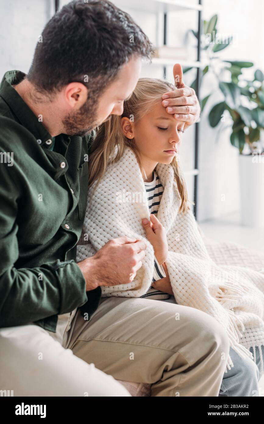 worried father touching forehead of diseased daughter Stock Photo - Alamy