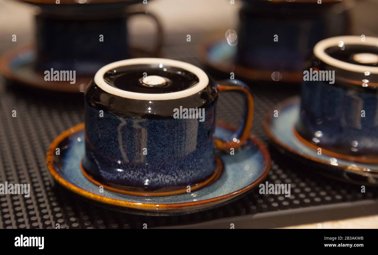 Clean dried hygienic vintage coffee drinking cups placed upside down on ...