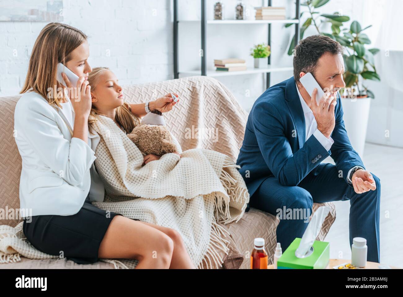 worried parents talking on smartphones while sitting near diseased ...