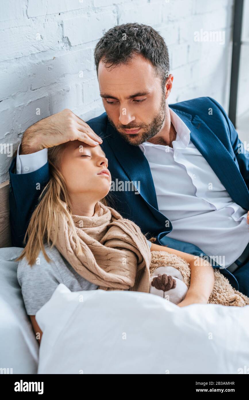 Father touching forehead sick hi-res stock photography and images - Alamy