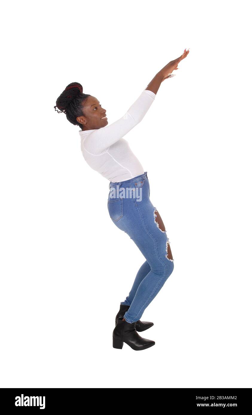 A young African American woman standing in jeans bending backwards and ...