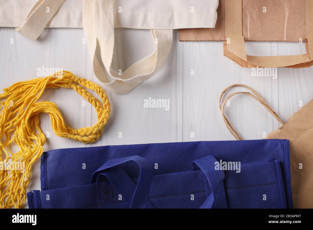Blue and white Shopping bags, yellow mesh bag and paper bags for ...