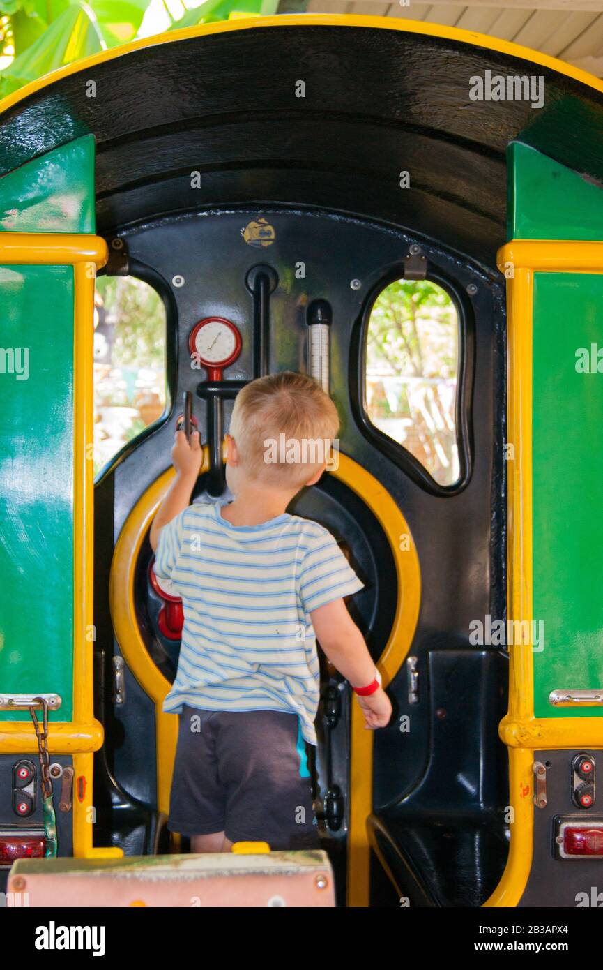 A little boy of three years rides in a children's train in the Riviera ...