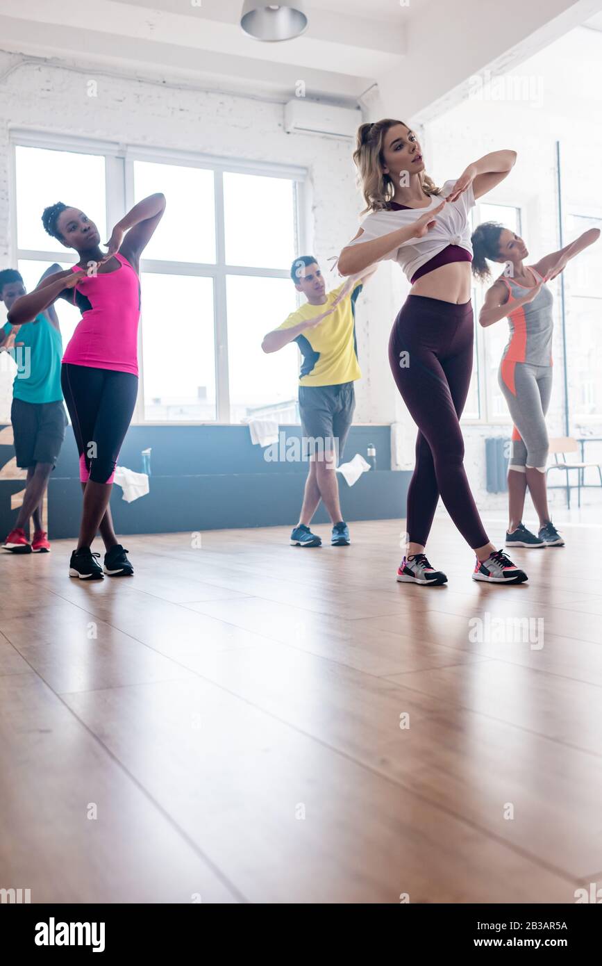 Low angle view of attractive zumba trainer exercising with ...