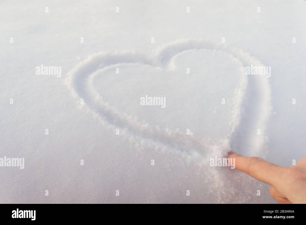 heart drawing by hand on fresh snow Stock Photo - Alamy
