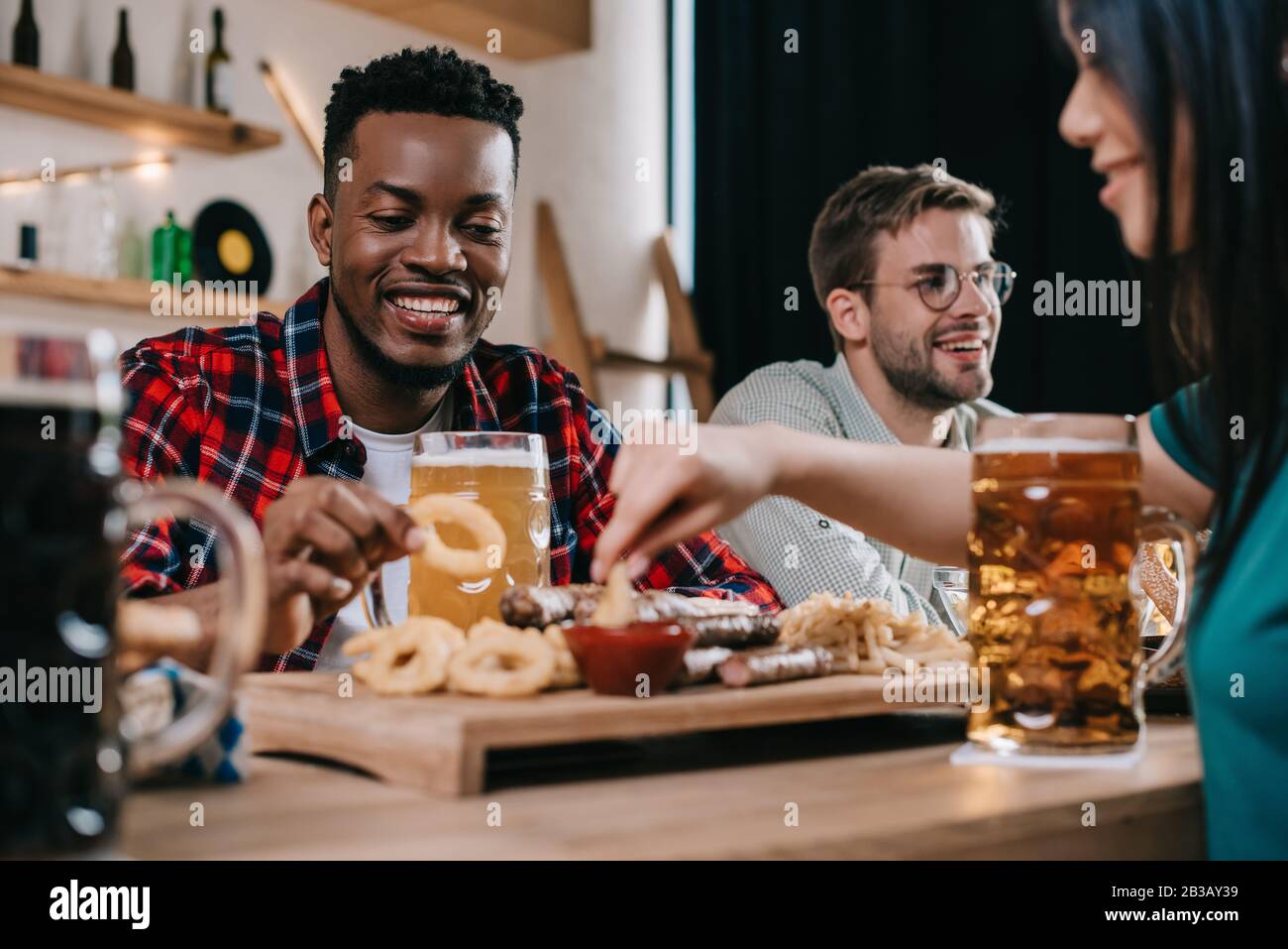 Smiling friends eating french hi-res stock photography and images - Alamy