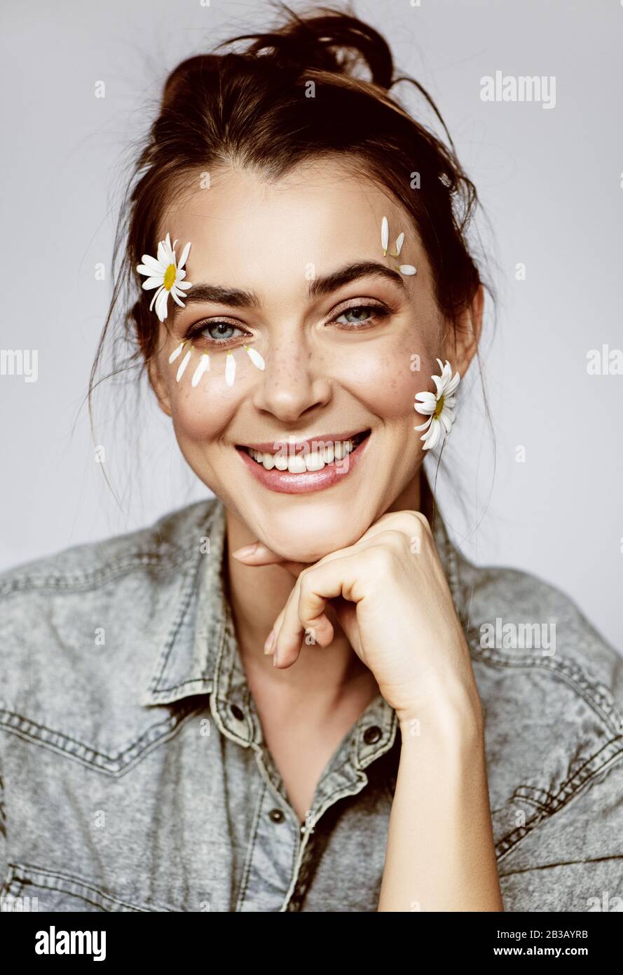 Beautiful young woman with flowers on her face. Spring concept Stock ...