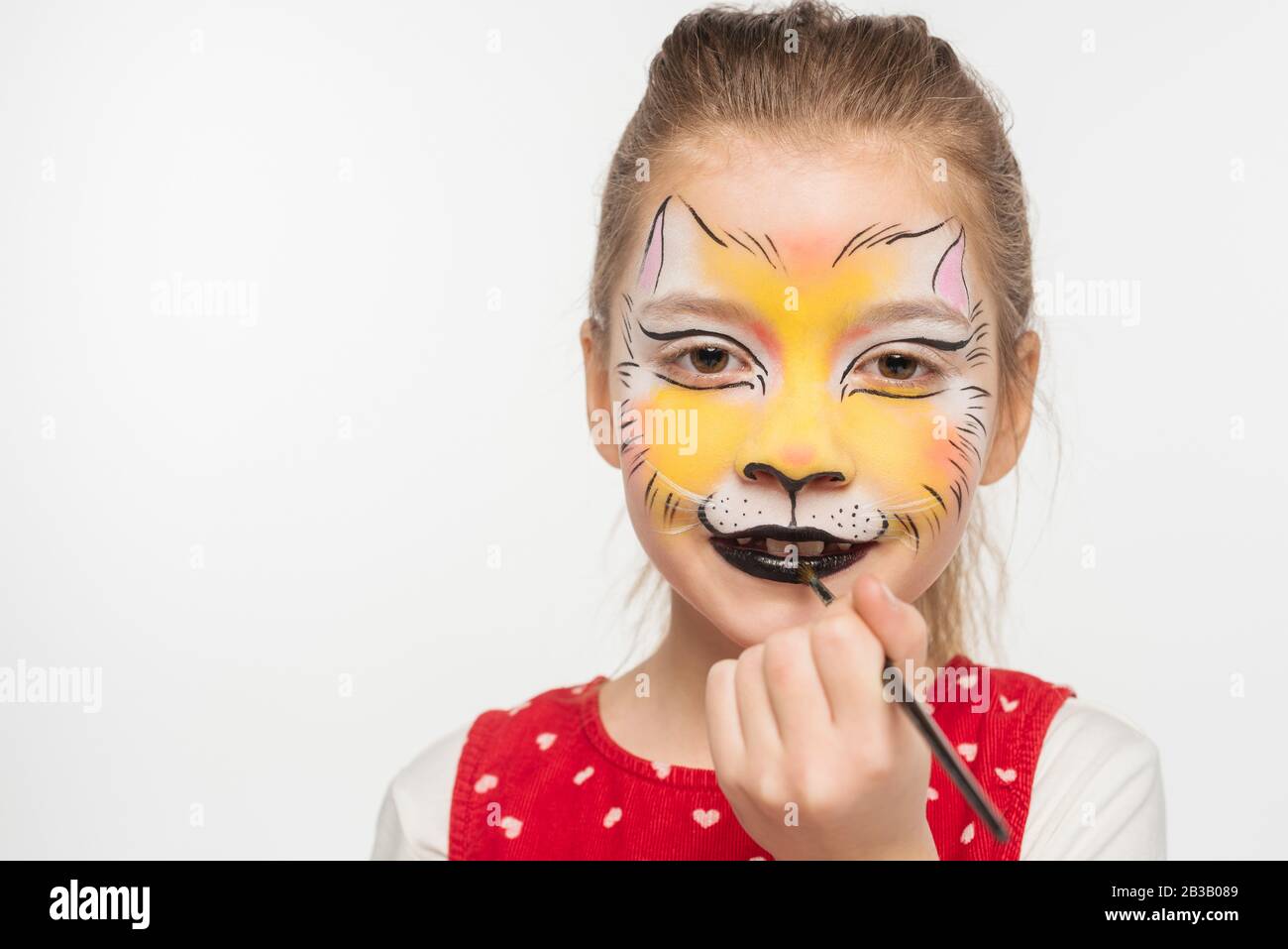cute kid with painted tiger muzzle on face painting on lips with ...