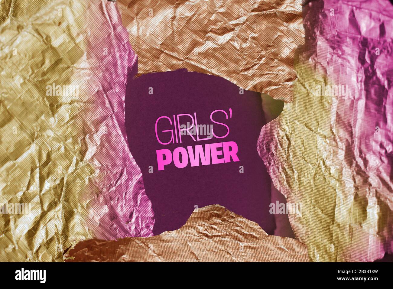 Torn golden foil paper on pink background with text Girls Power. Ripped ...