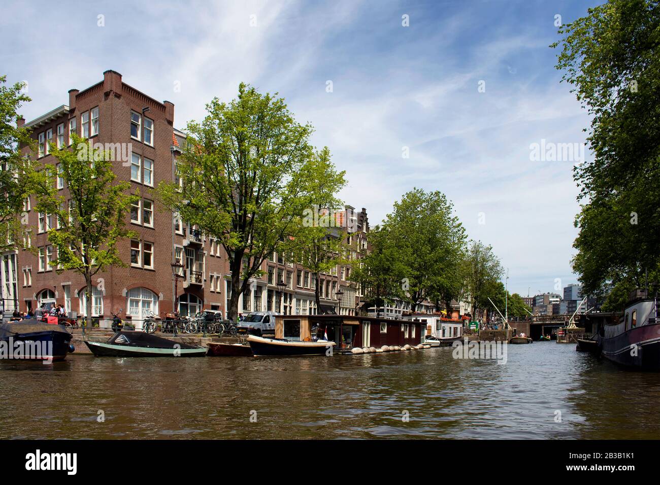View of canal, boat houses, trees, historical and traditional buildings ...