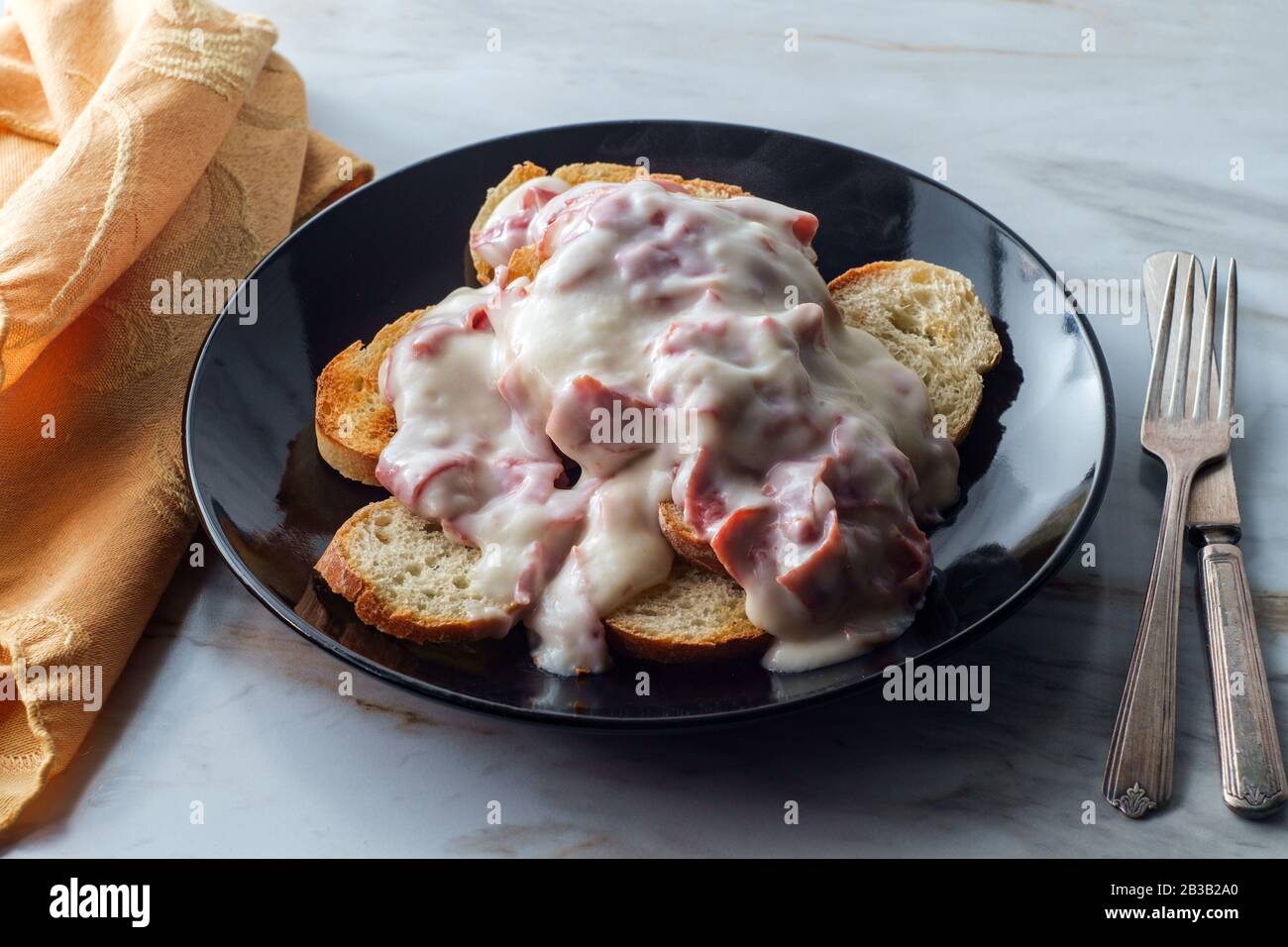 Creamed and chipped beef on sliced toast on marble kitchen table also ...