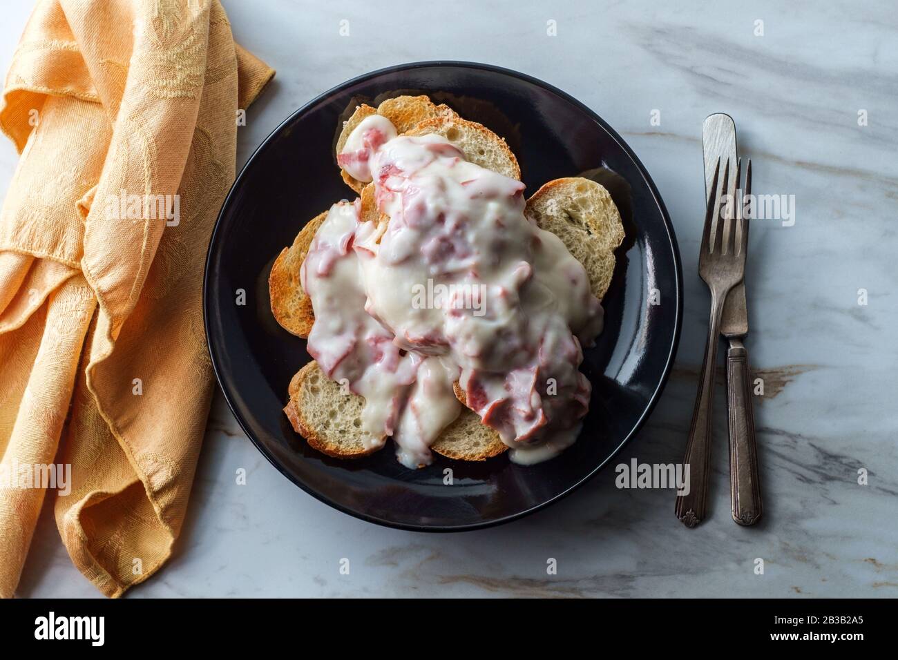 Creamed and chipped beef on sliced toast on marble kitchen table also ...