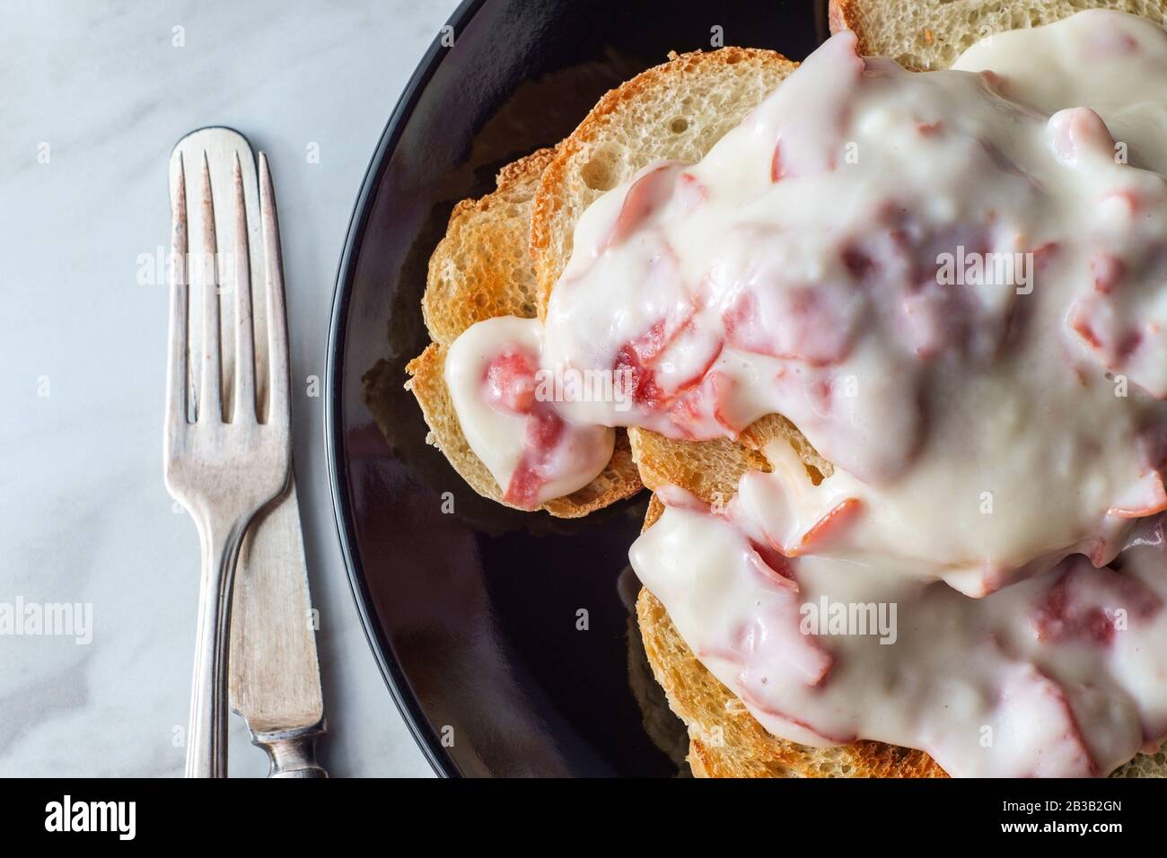 Creamed and chipped beef on sliced toast on marble kitchen table also ...