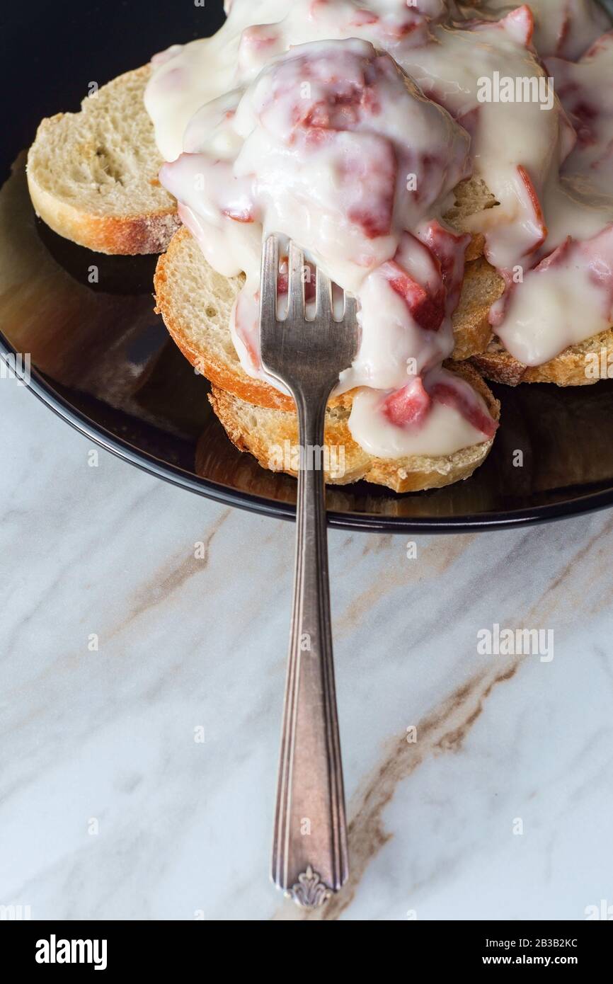 Creamed and chipped beef on sliced toast on marble kitchen table also ...