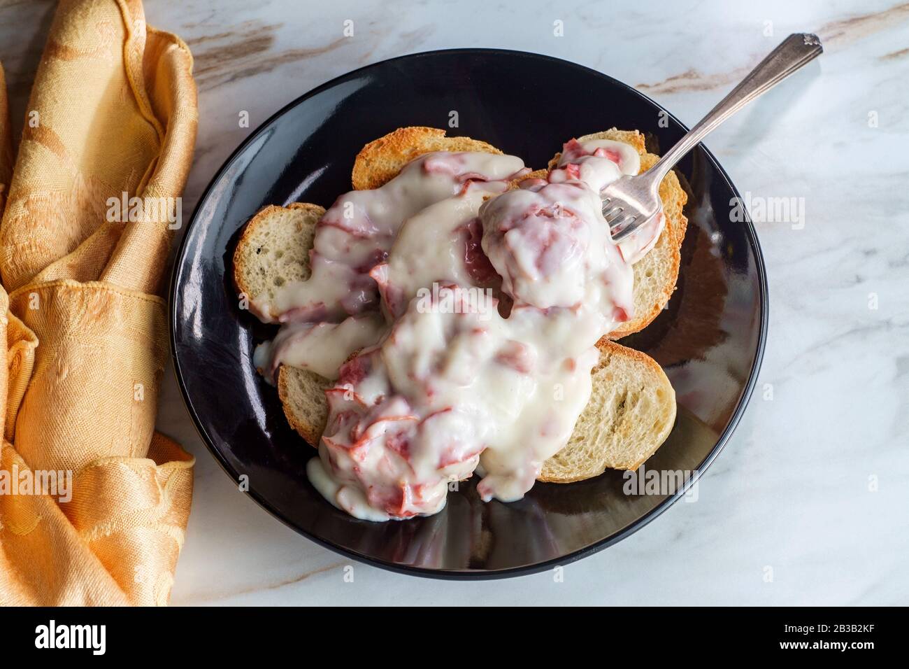 Creamed and chipped beef on sliced toast on marble kitchen table also ...