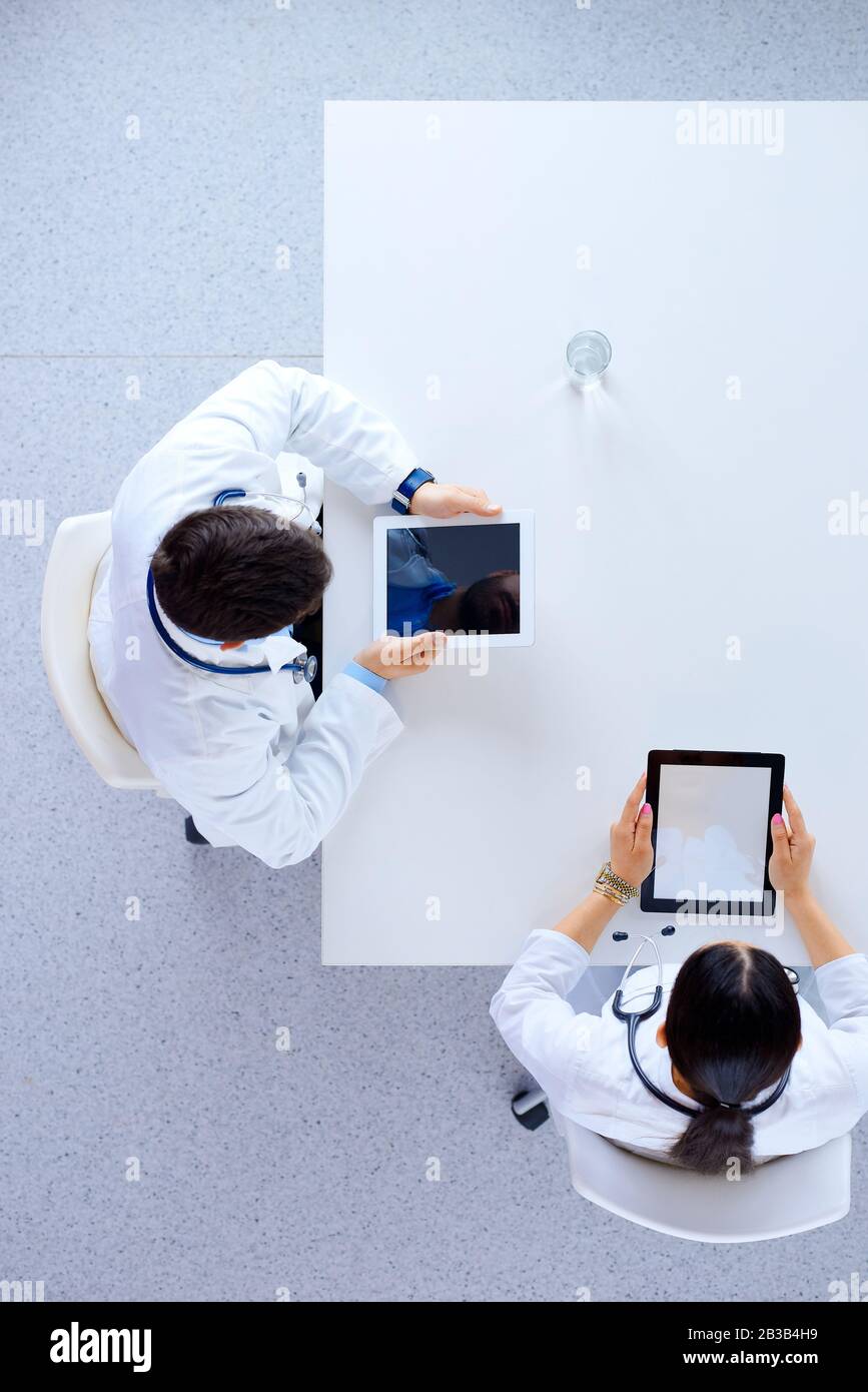 Flat lay, top view. Professional doctors at hospital with tablets ...