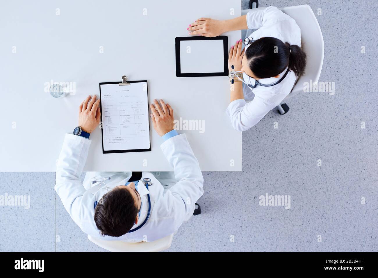 Flat lay, top view. Professional doctors at hospital with tablets ...