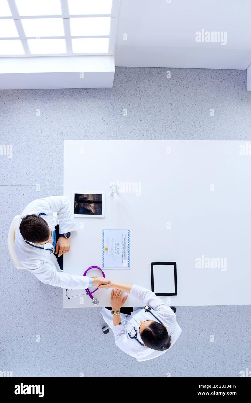 Top view, group of doctors in the office at the table handshaking ...