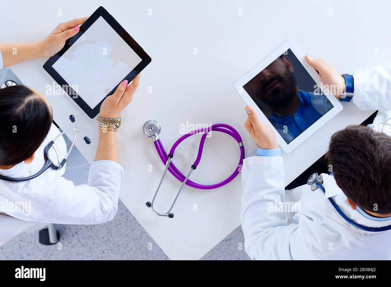 Flat lay, top view. Professional doctors at hospital with tablets ...