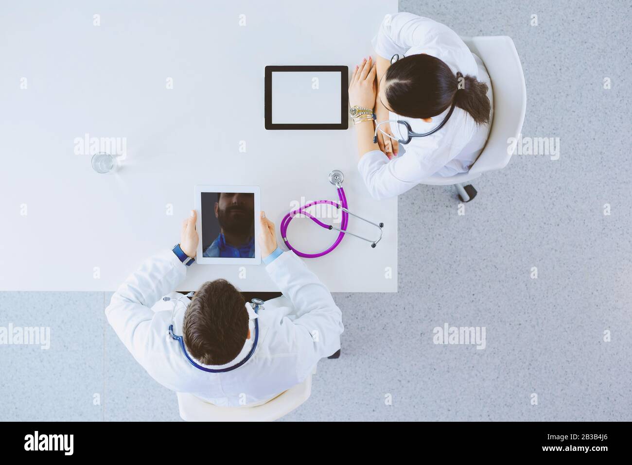 Flat lay, top view. Professional doctors at hospital with tablets ...