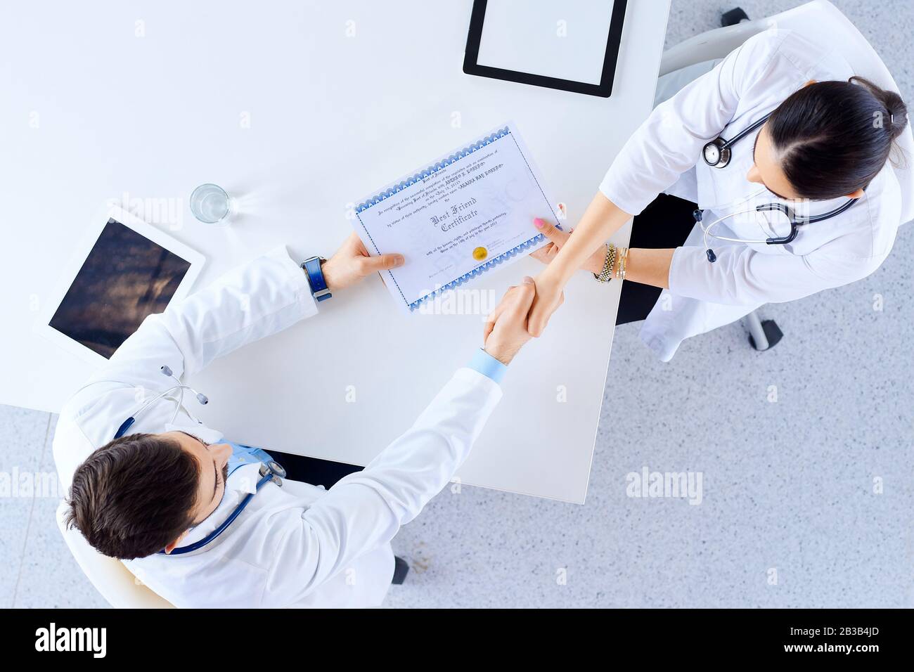 Doctor gives diploma intern in hospital Stock Photo - Alamy