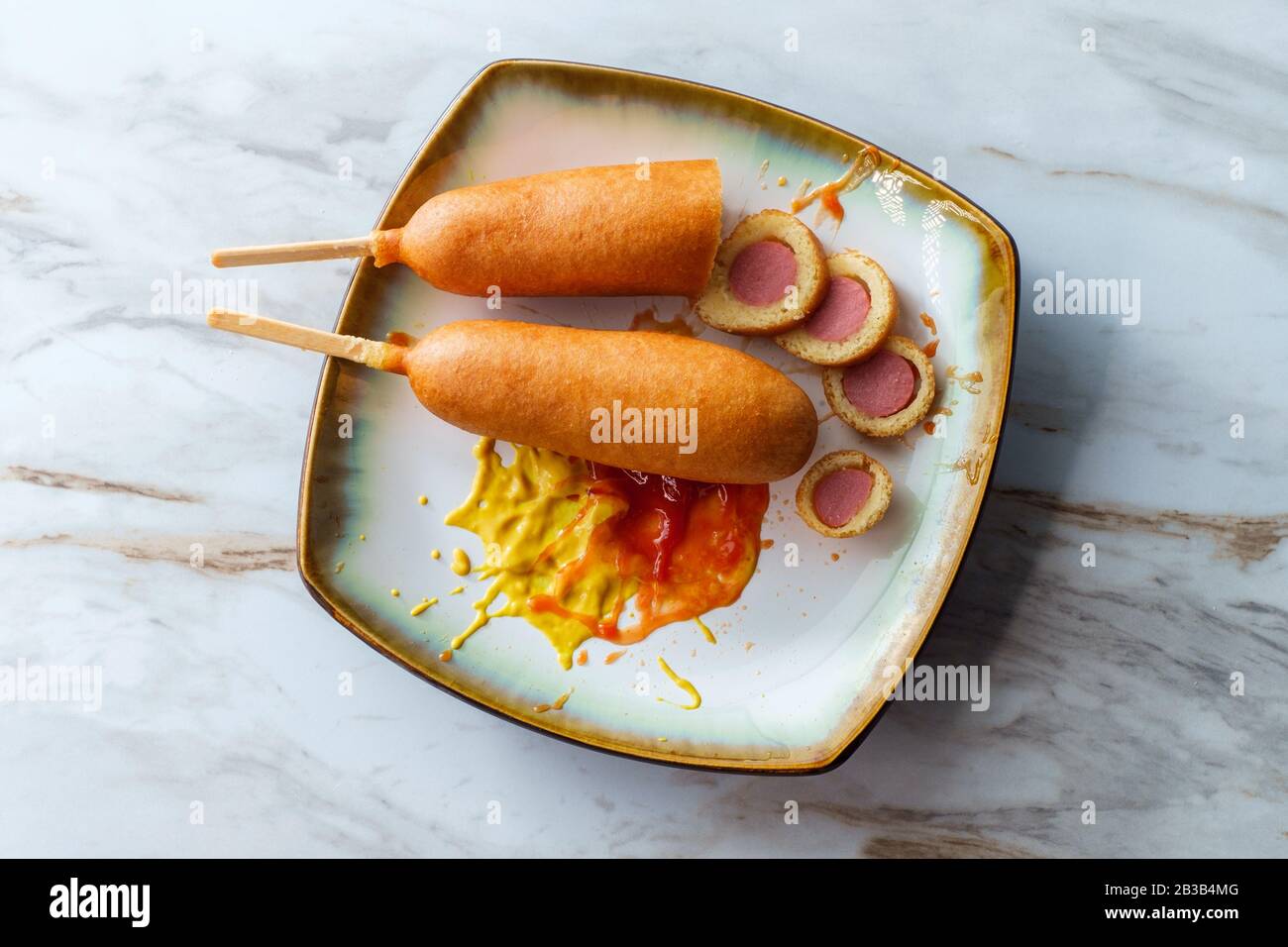 American fast-food cuisine messy corn dog Stock Photo - Alamy