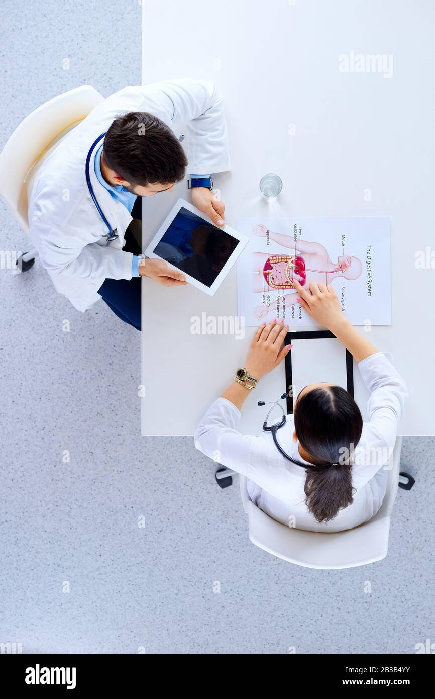 Medical team sitting discussing table hi-res stock photography and ...