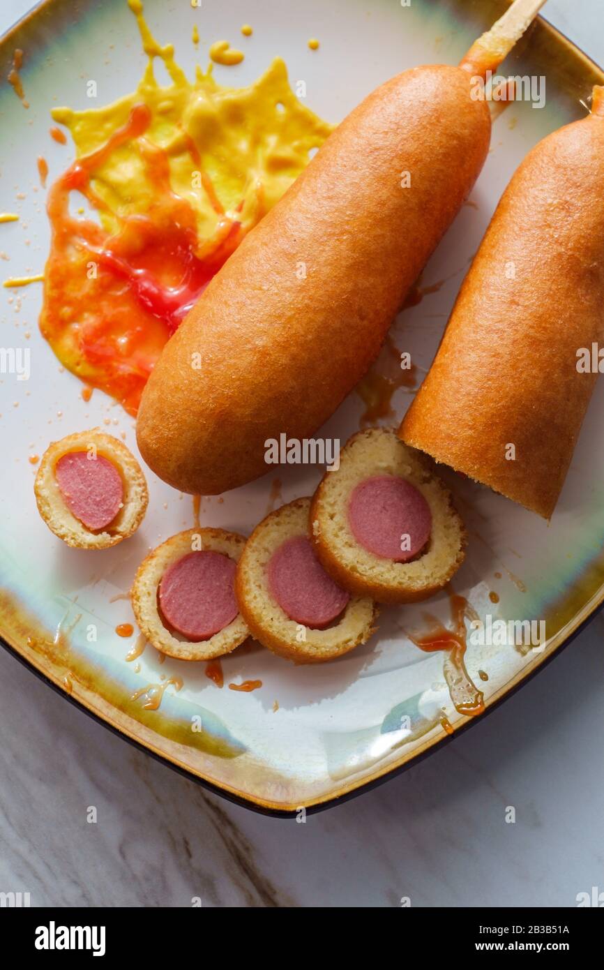 American fast-food cuisine messy corn dog Stock Photo - Alamy