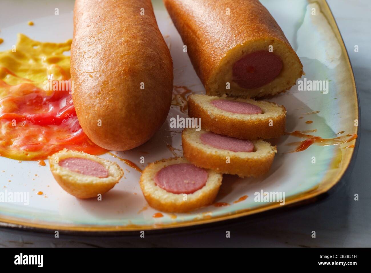 American fast-food cuisine messy corn dog Stock Photo - Alamy