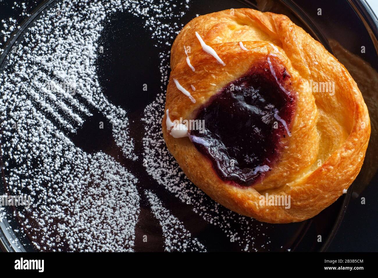 Blueberry glazed danish dessert pastry with icing and powdered sugar ...