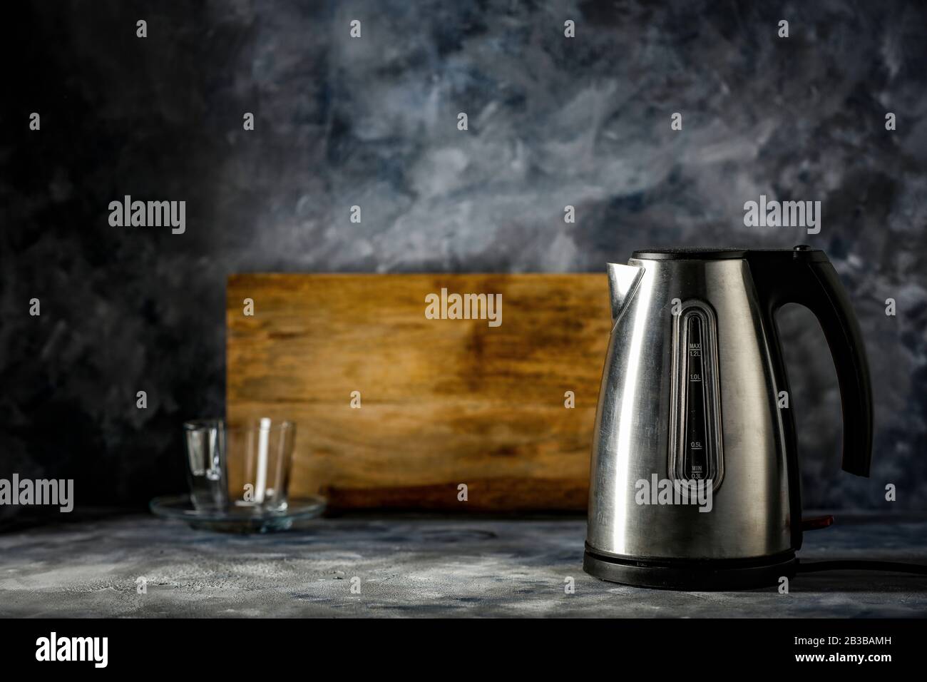 Electric kettle and dark mood wall background. Copy space for your ...